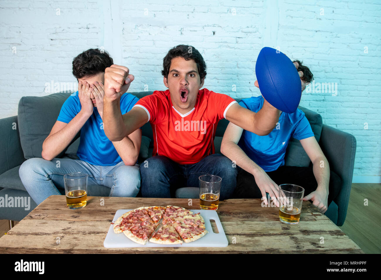 young group of caucasian football fans disappointed and happy watching ...