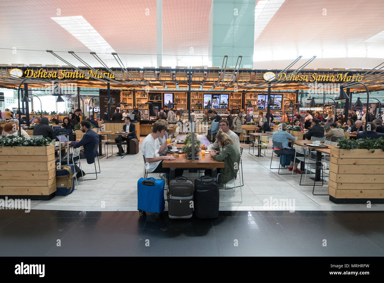Barcelona airport, Spain passengers in a restaurant have a fast lunch ...