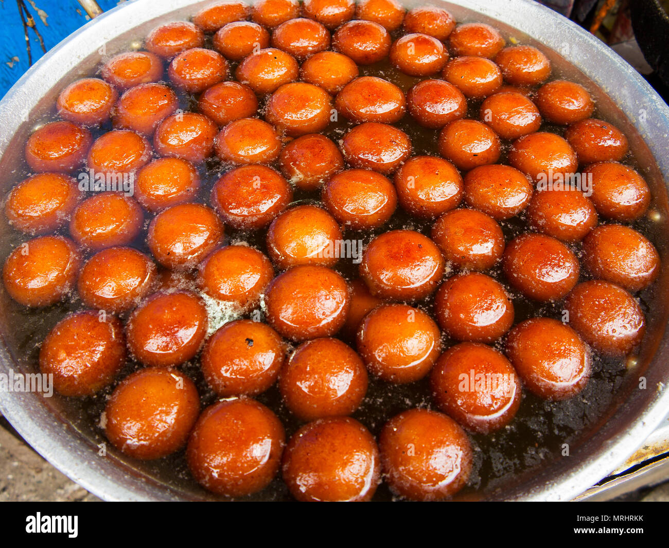 Gulab Jamun being made at a typical indian sweet indian restaurant at ...