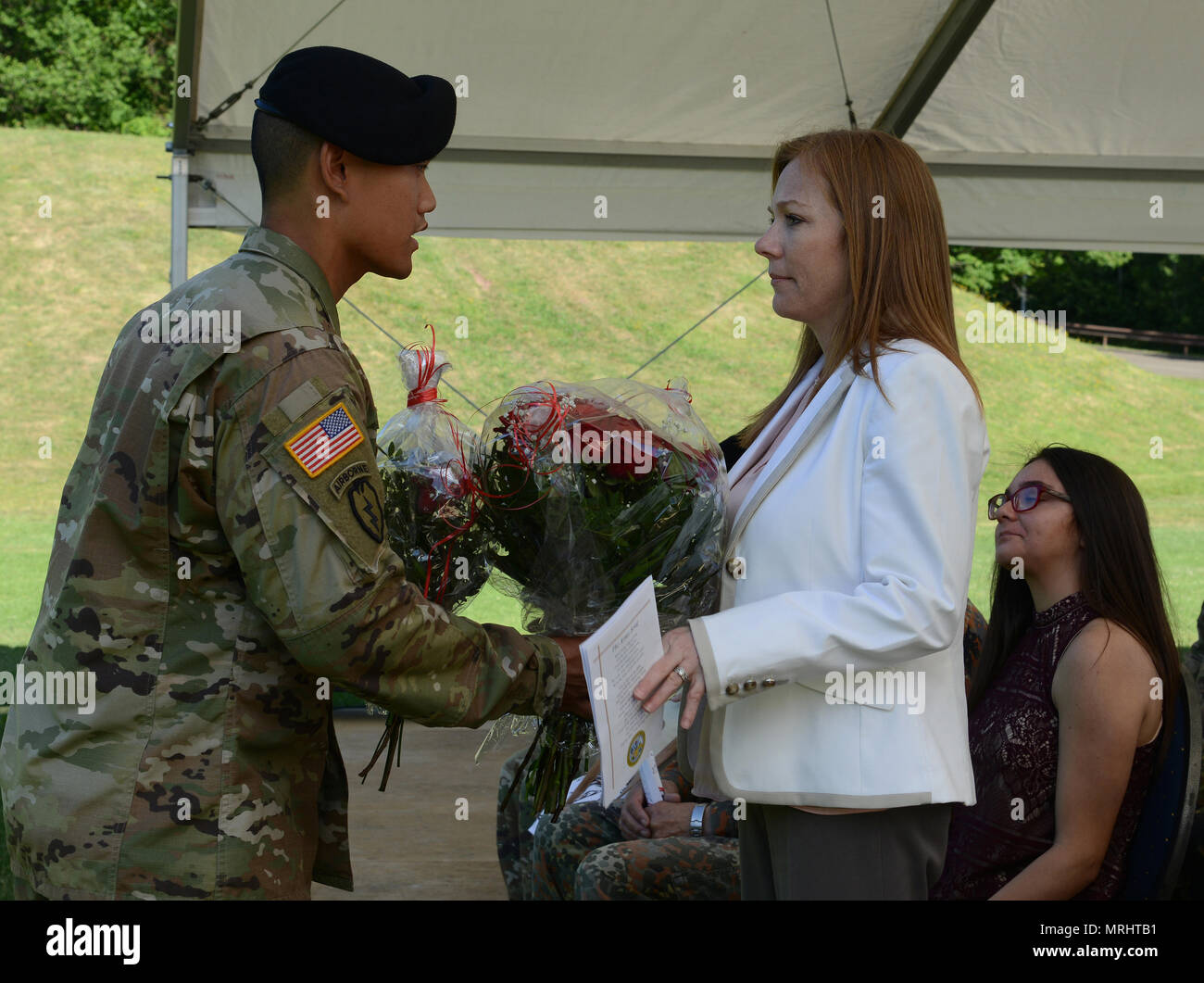 Red roses are presented to Roxanne O’Neal, wife of Command Sgt. Maj ...