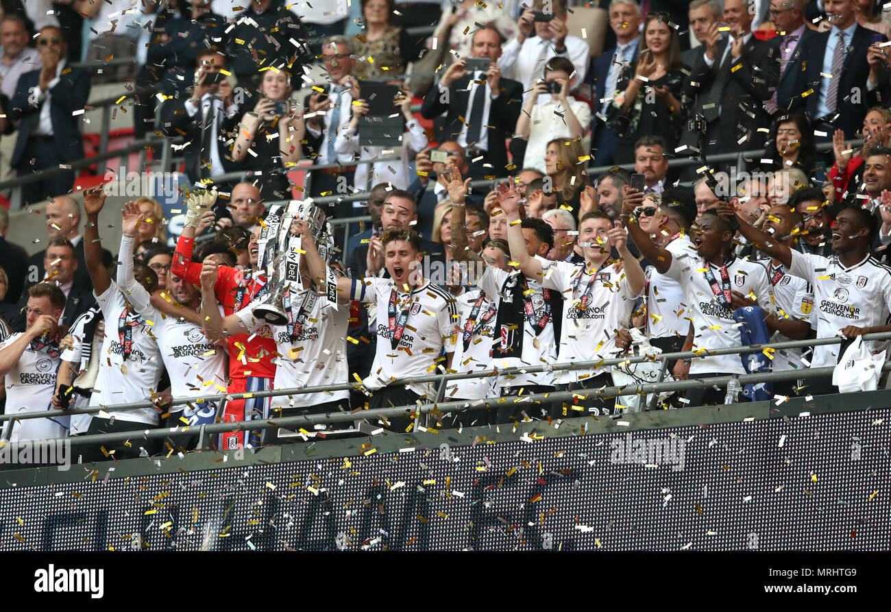 Fulham's Tom Cairney lifts the trophy after the final whistle during ...