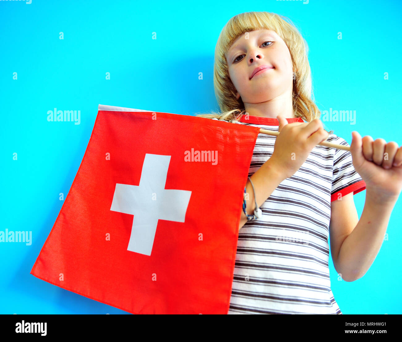 Cute blonde boy holding national flag of Switzerland Stock Photo - Alamy