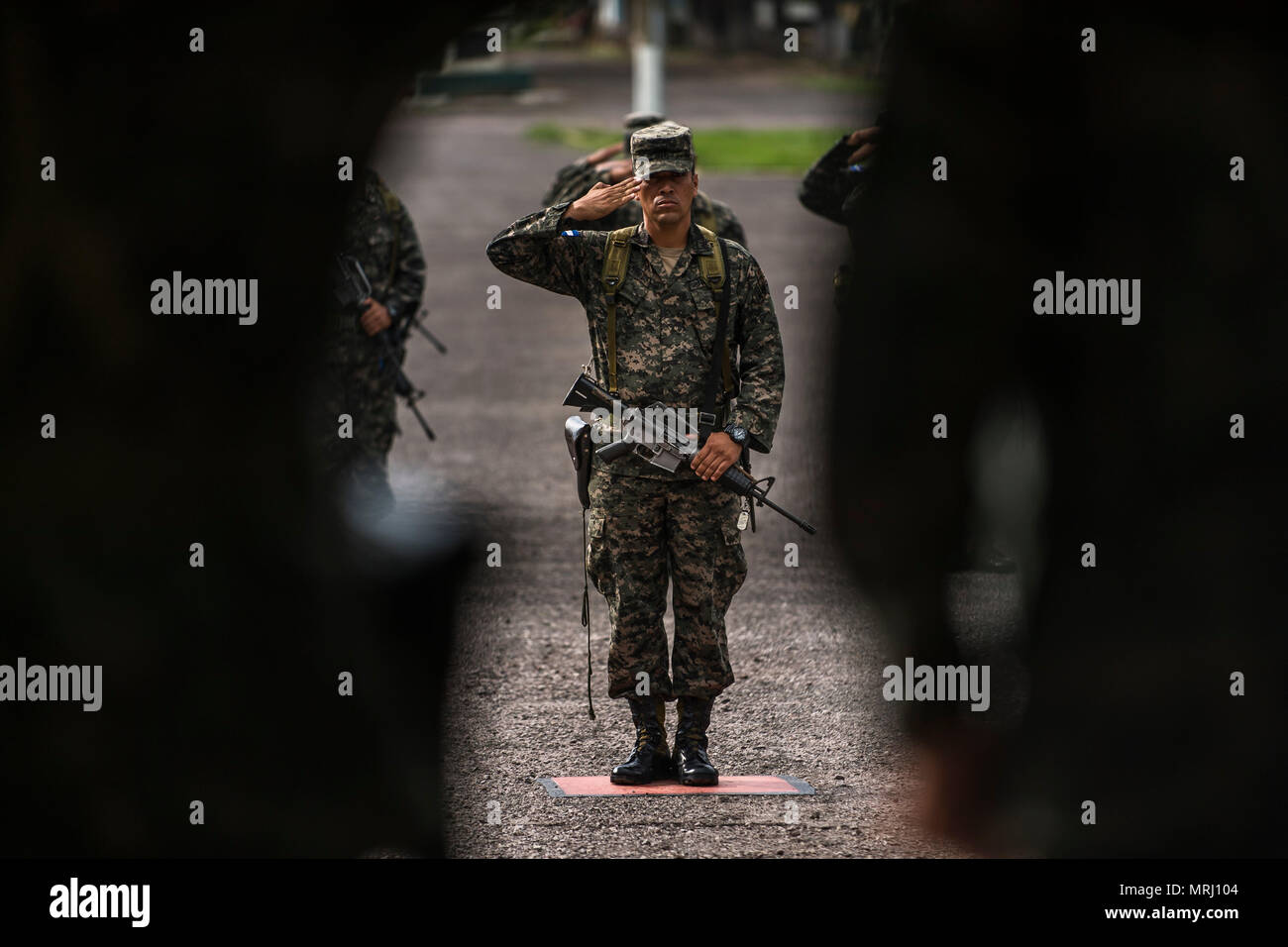 A Honduran military soldier salutes the flag as both nations anthem is ...