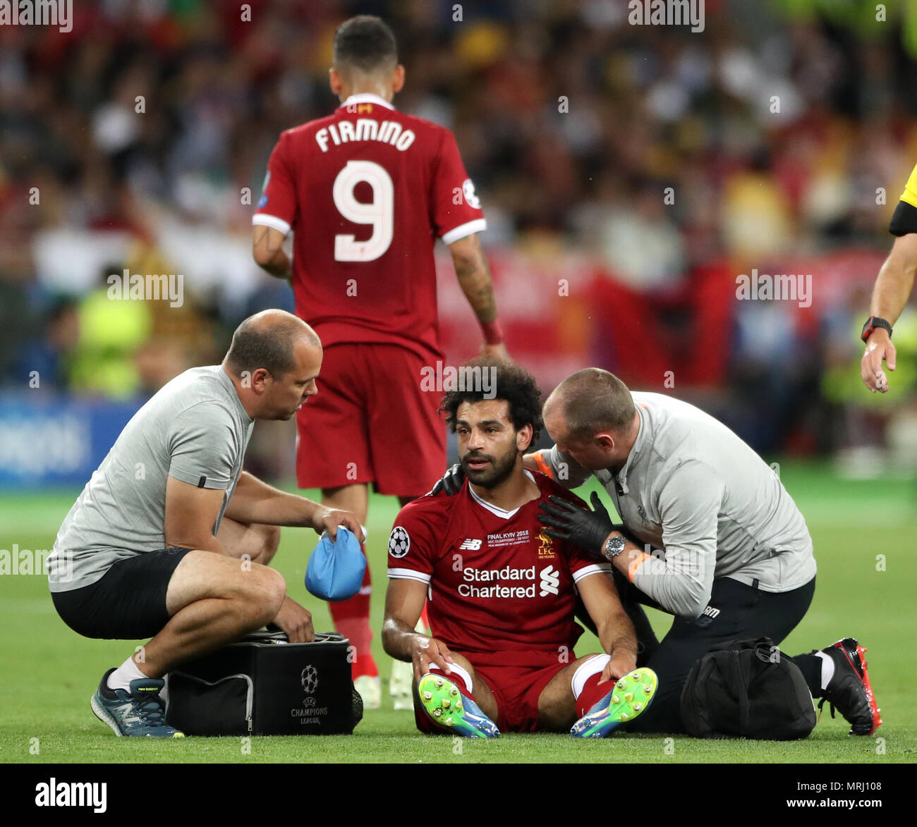 Liverpool's Mohamed Salah reacts after picking up an injury during the ...