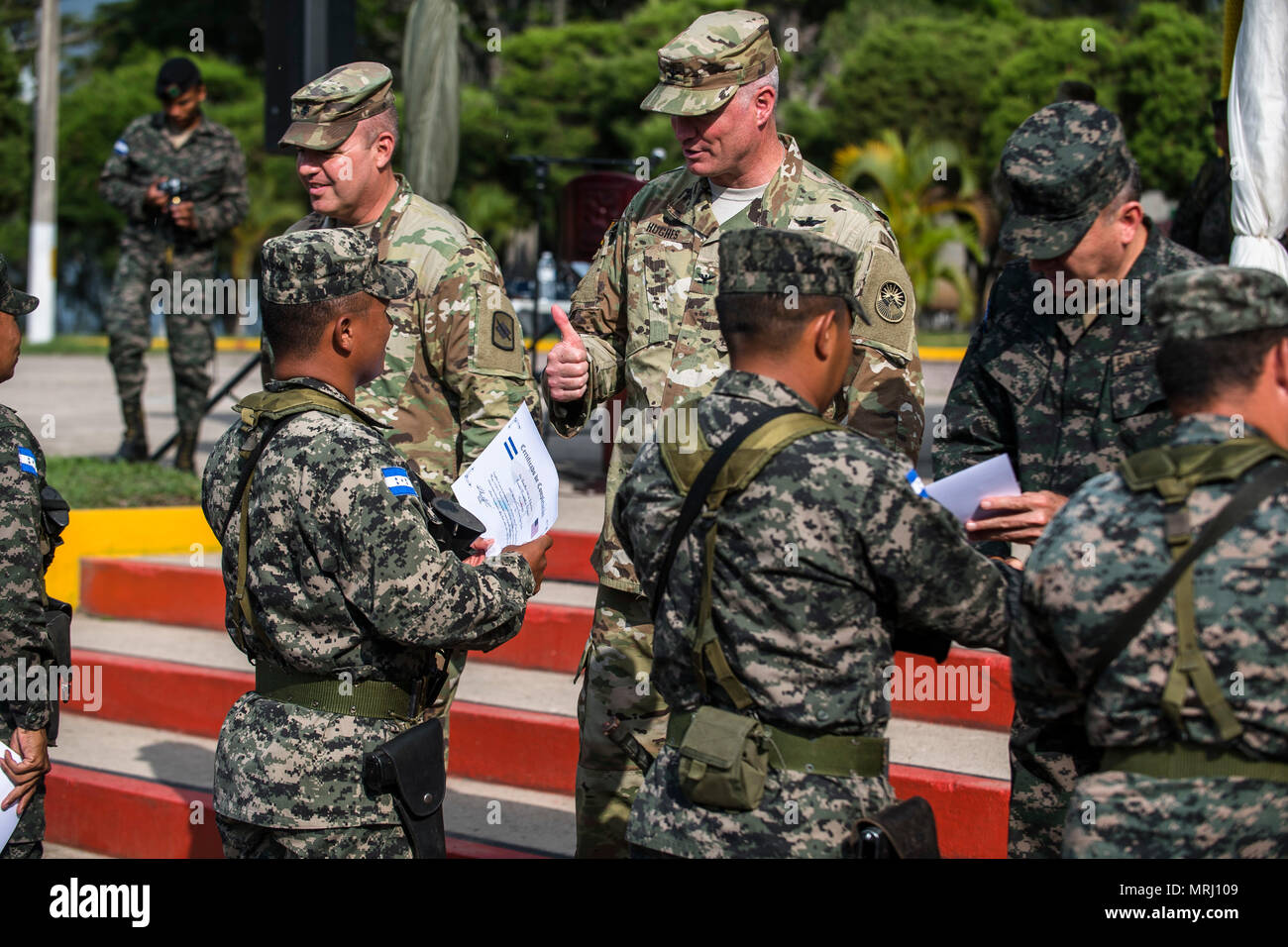 Col. Brian Hughes, Commander of Joint Task Force – Bravo hands a ...
