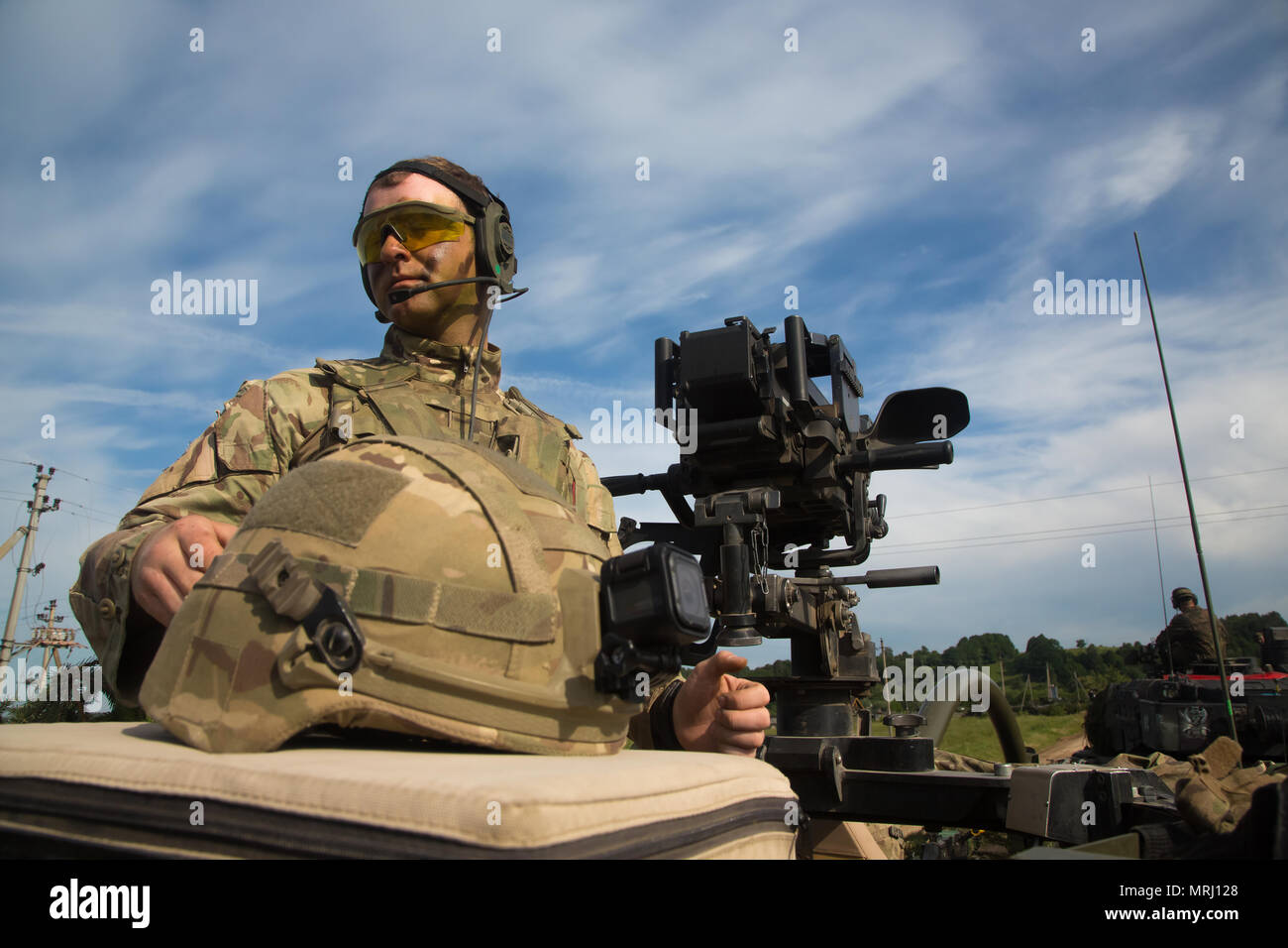 U.K. soldier Cpl. Wayne Pennington puts on his equipment during Saber ...