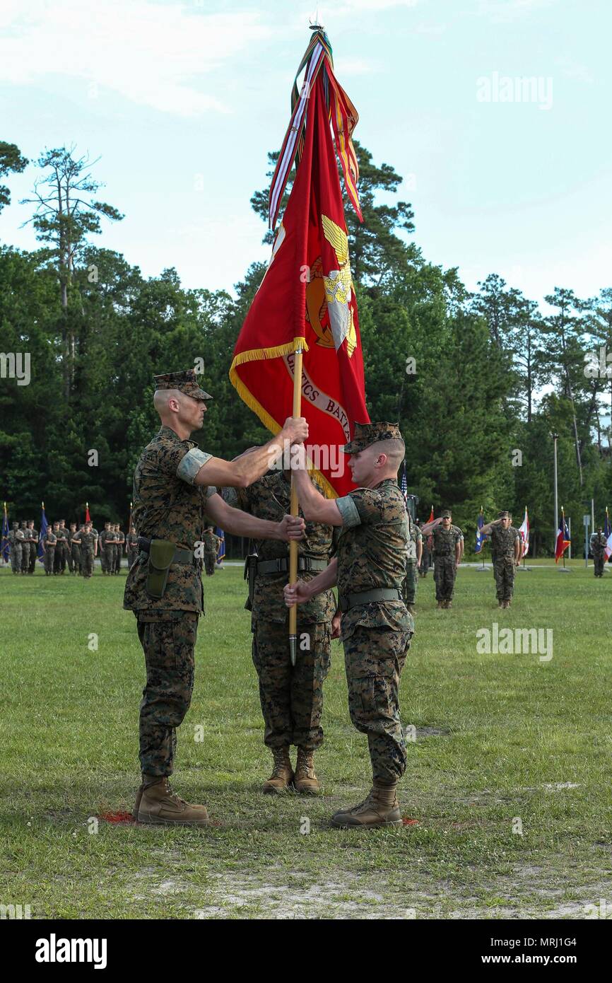 U.S. Marine Corps Lt. Col. Todd B. Sanders, right, passes the Marine ...