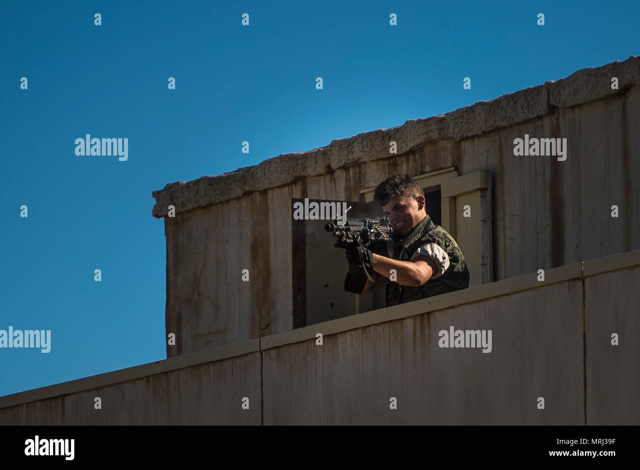 A member of opposition forces fires at U.S. Army Reserve Soldiers from ...