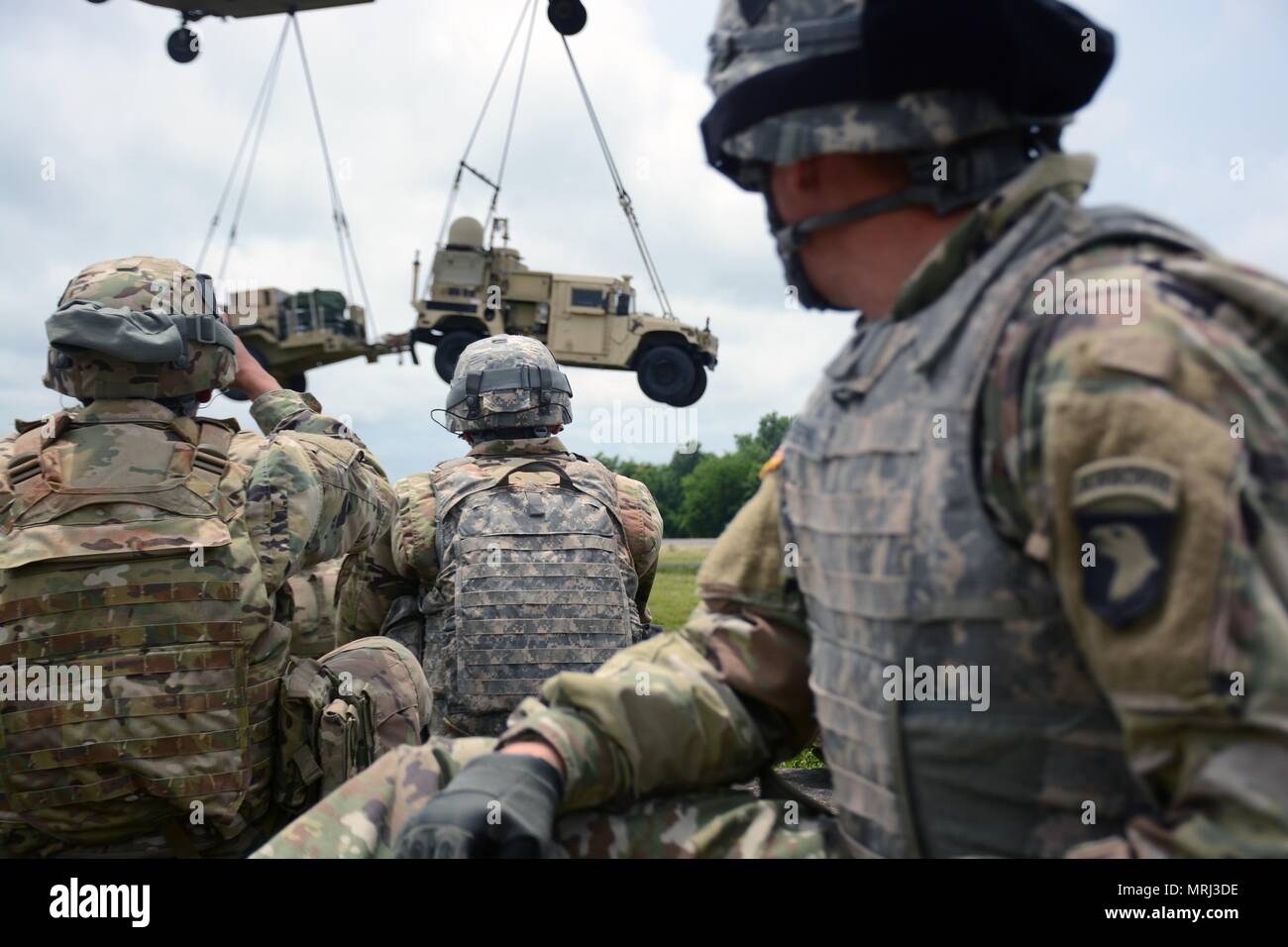 U.S. Army Soldiers from the 2nd Brigade Combat Team, 101st Airborne Division (Air Assault) watch ...