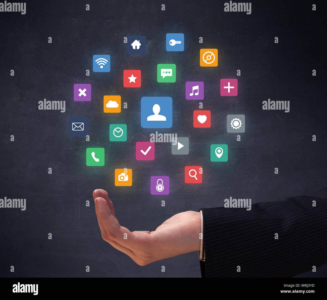 Colorful applications hovering over young hand Stock Photo - Alamy