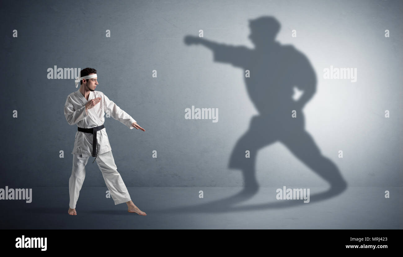 Young karate man confronting with his own shadow Stock Photo - Alamy