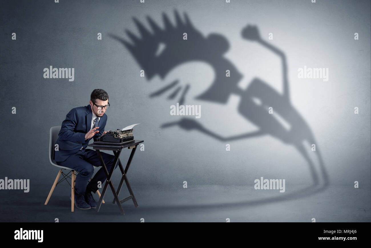 Man working hard and he is afraid of a yelling shadow Stock Photo - Alamy