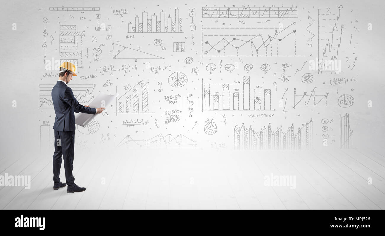 Engineer with construction helmet holding a plan and standing with ...