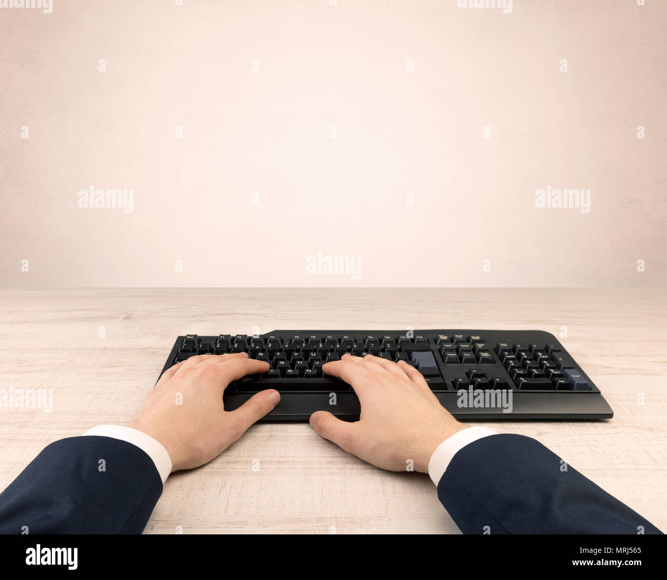 First person view of an elegant businessman hand typing on light ...
