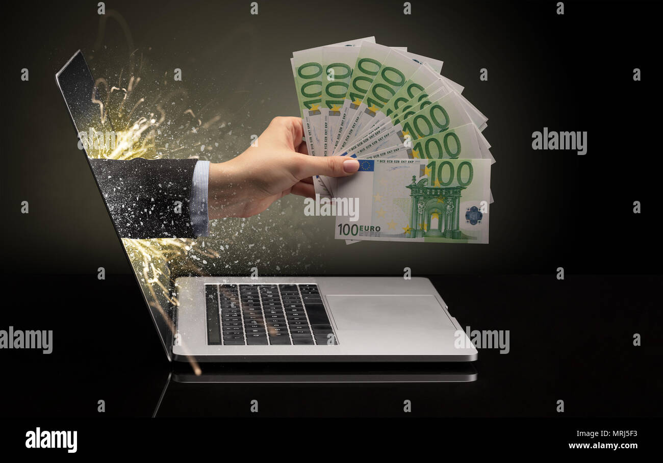 Hand with money coming out of a laptop with sparkling effects Stock ...