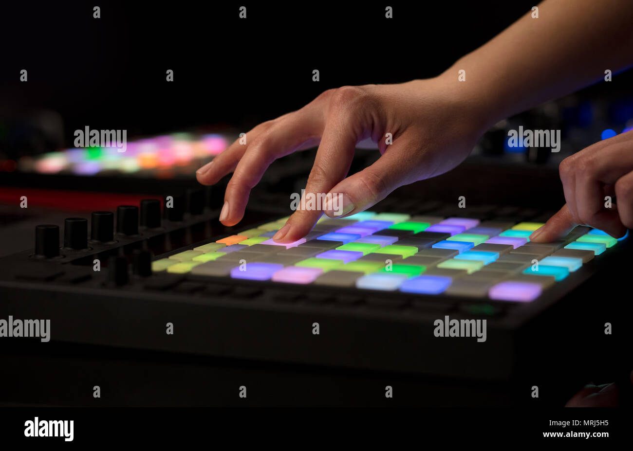 Dj hand remixing music on midi controller Stock Photo - Alamy