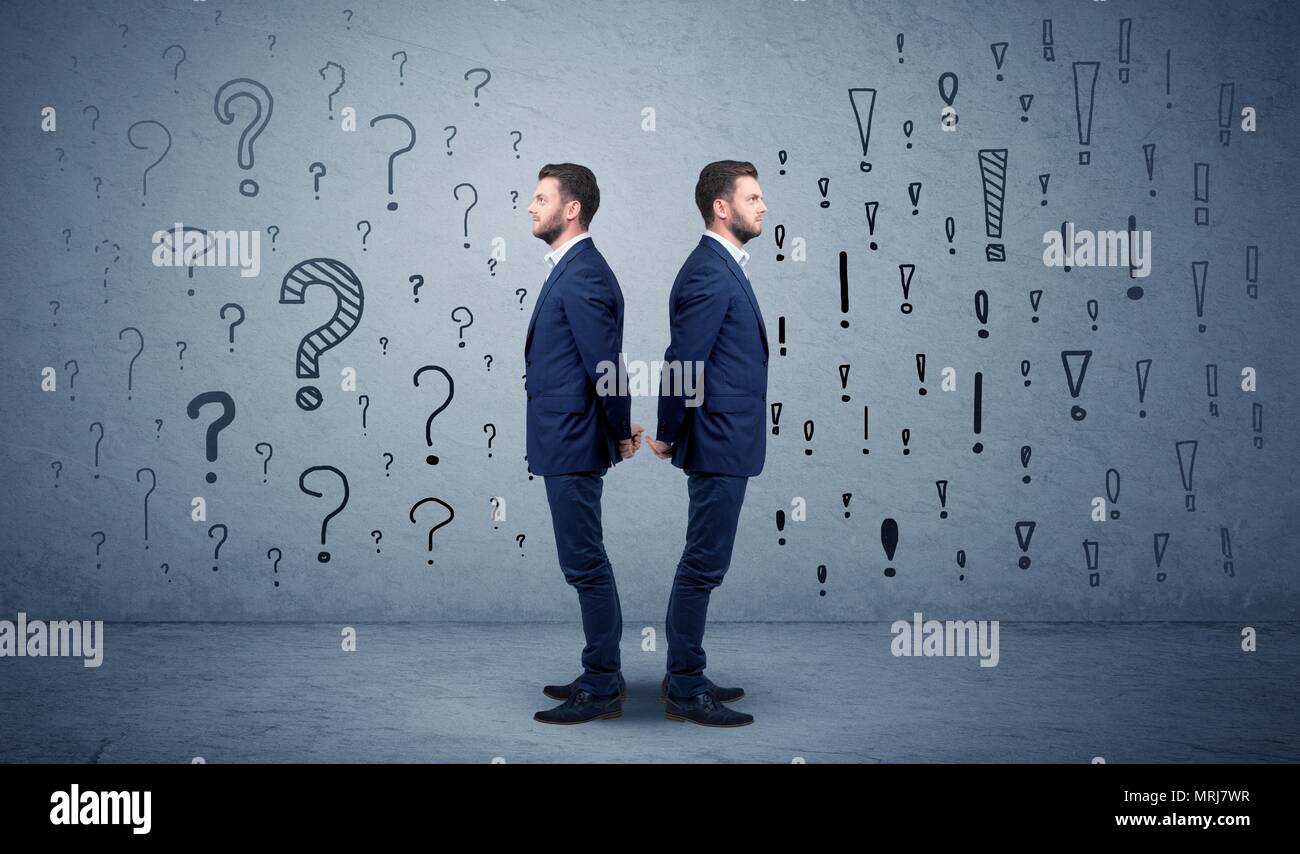 Young conflicted businessman choosing between two directions with ...