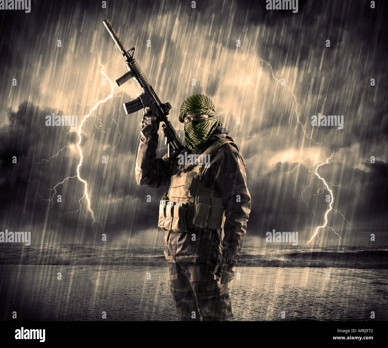 Portrait of a dangerous armed terrorist with mask and gun in a ...