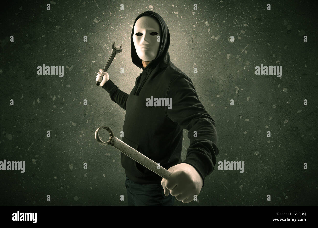 Masked armed villain in empty dark room with gun ax chainsaw mallet ...