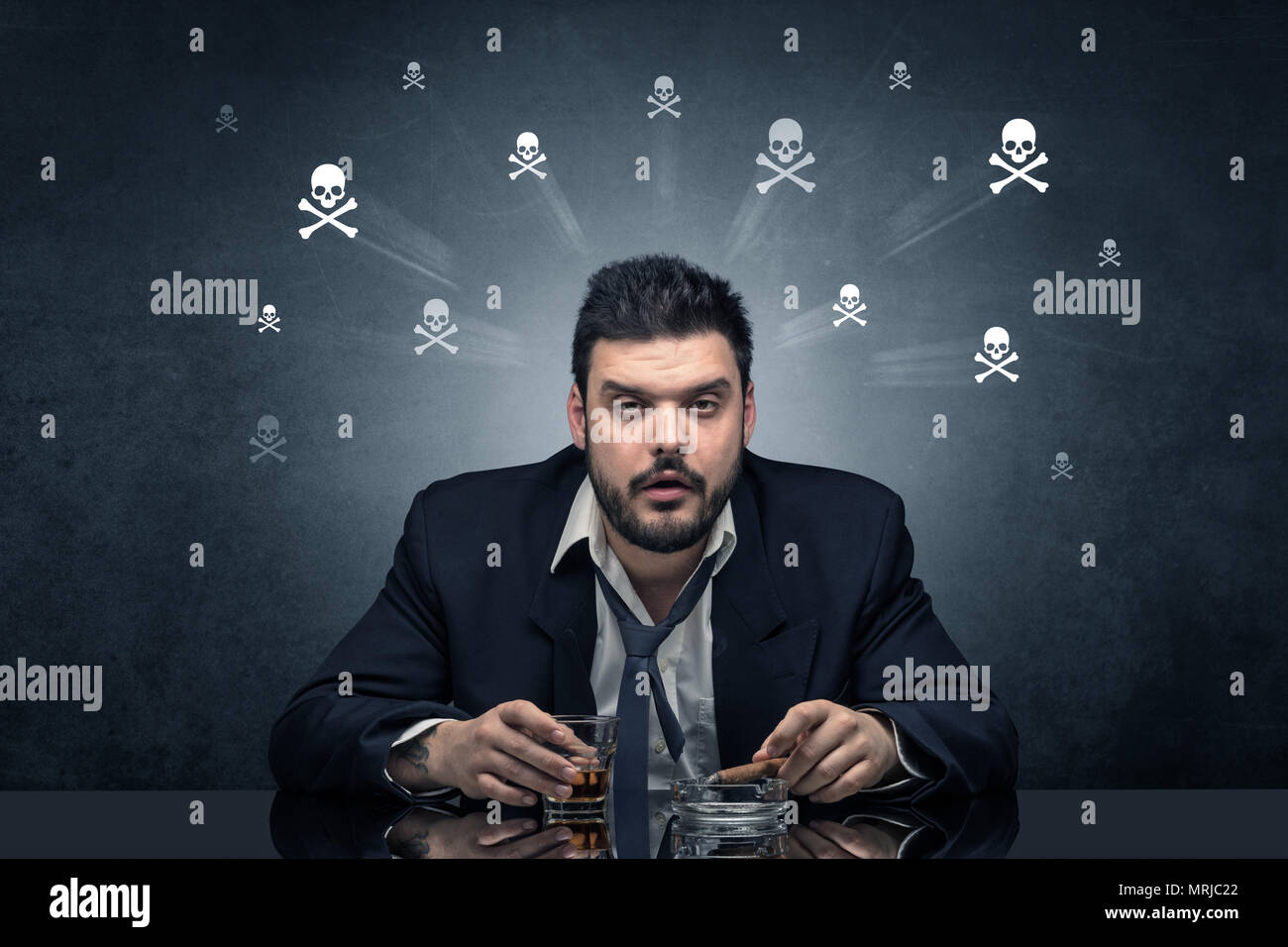 Loser drunk man sitting at table with skulls concept around Stock Photo ...