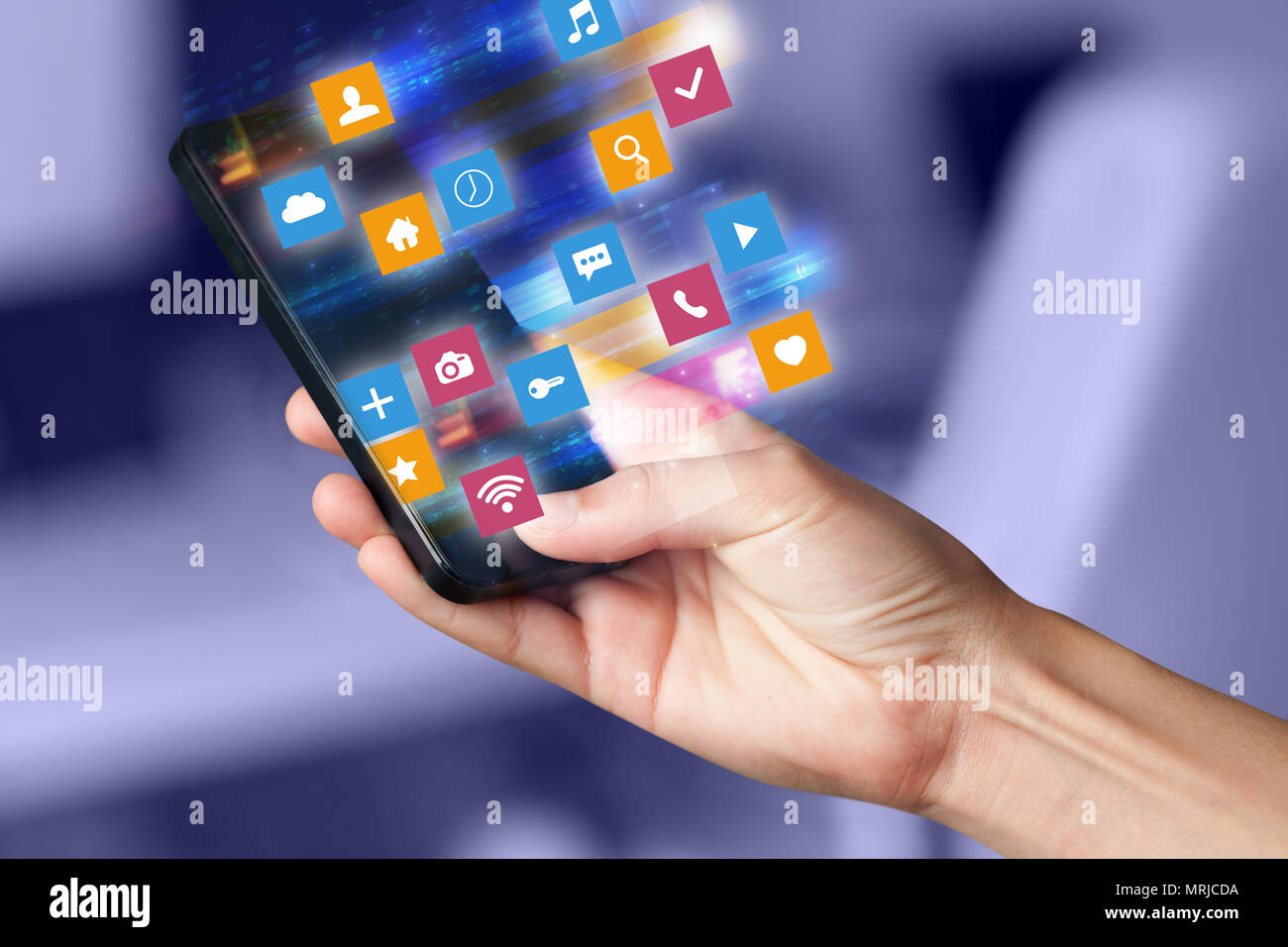 Hand using phone with colorful fast moving application icons and ...
