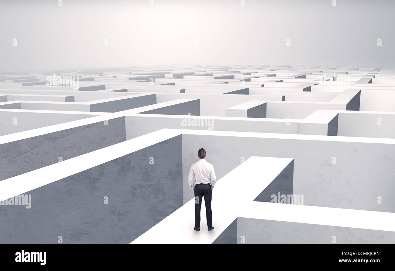 Small businessman in a middle of a huge maze Stock Photo - Alamy