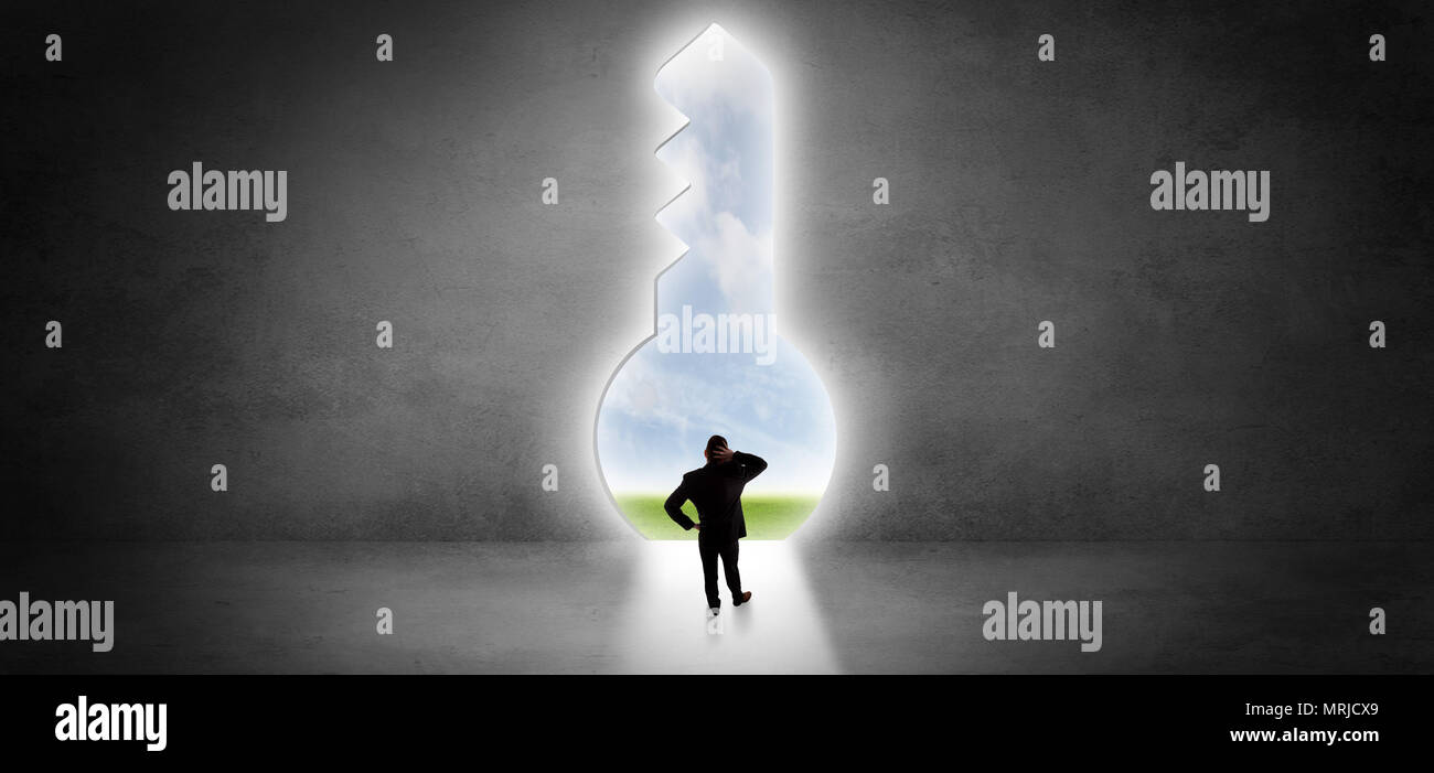 Businessman standing alone in front of a big keyhole Stock Photo - Alamy