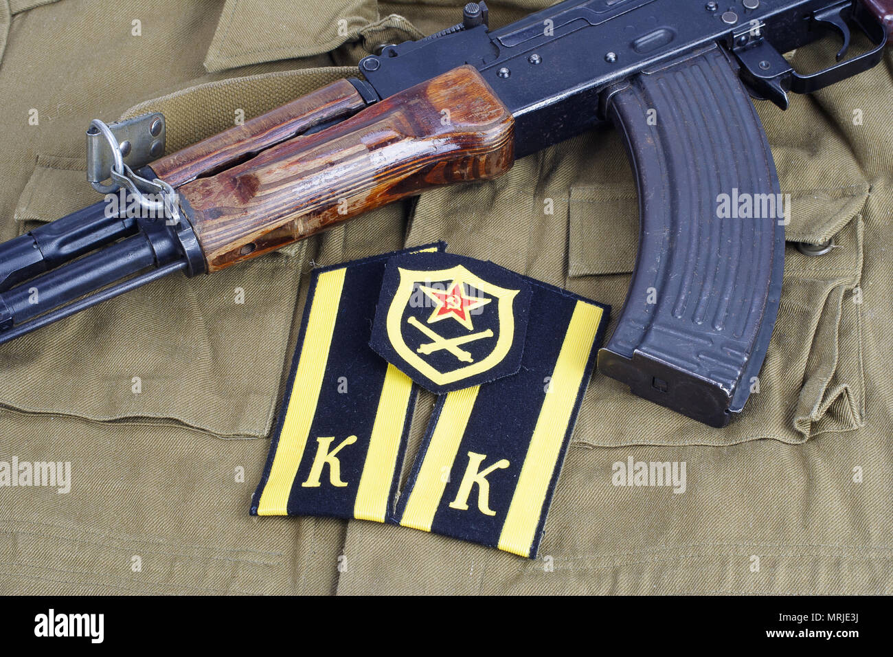 AK47 with Soviet Army Cadet shoulder mark on khaki uniform background ...