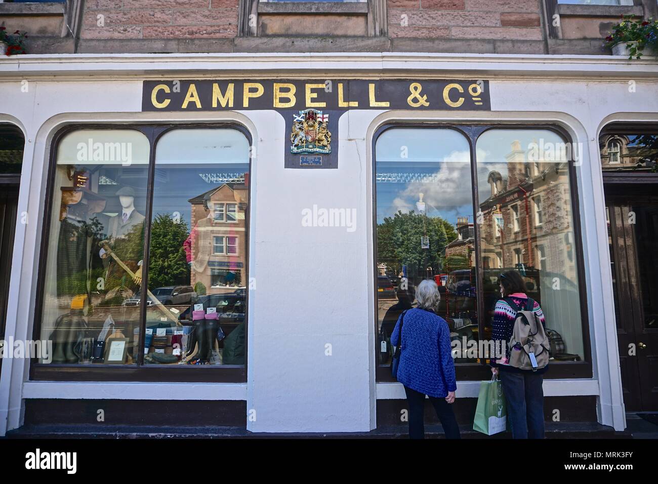 Beauly, Inverness County, Scotland, UK: Shoppers gaze at the window ...