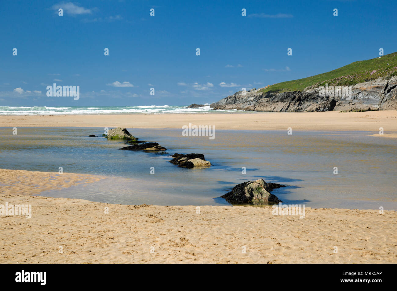 Rock features on Perranporth beach, Cornwall on a sunny day with blue ...