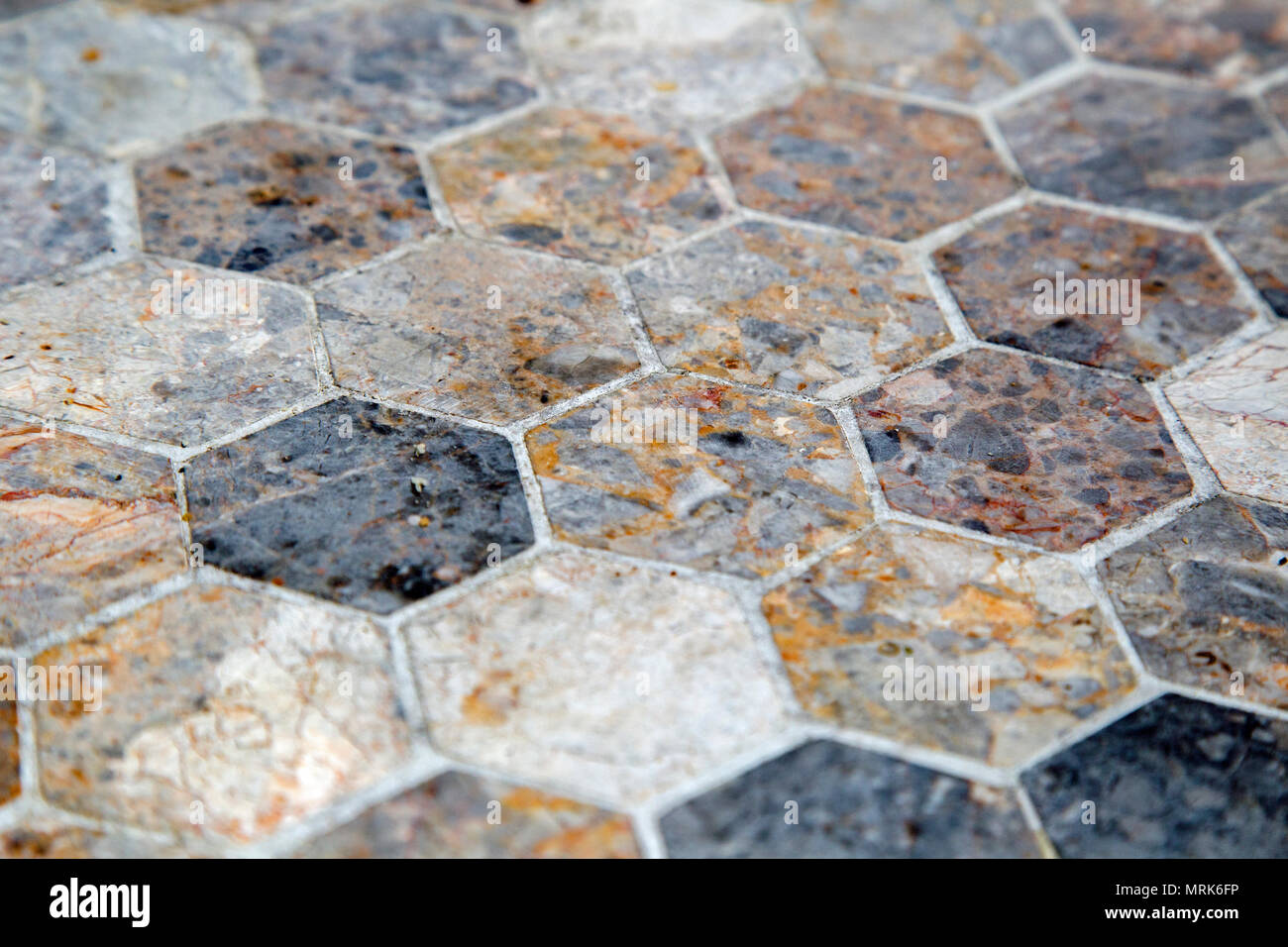 Hexagonal stone pieces on a table top for a background Stock Photo - Alamy