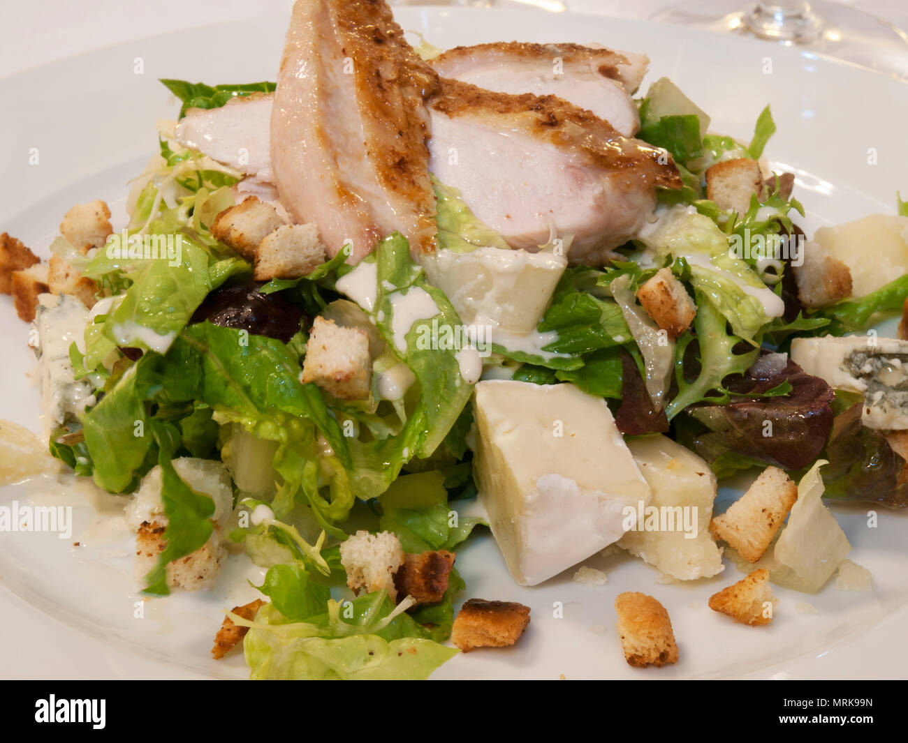 Roasted chicken leg with salad and cheese Stock Photo - Alamy