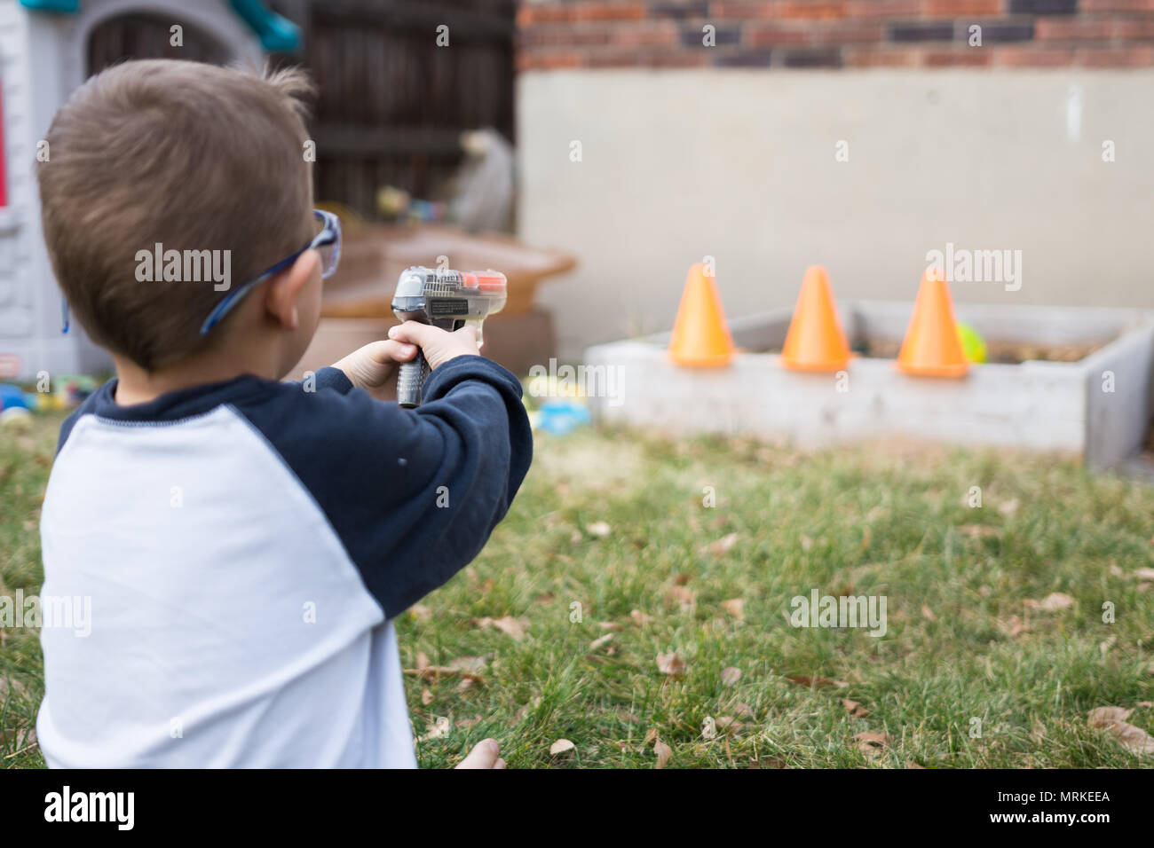 Small boy does target practice with airsoft gun Stock Photo - Alamy