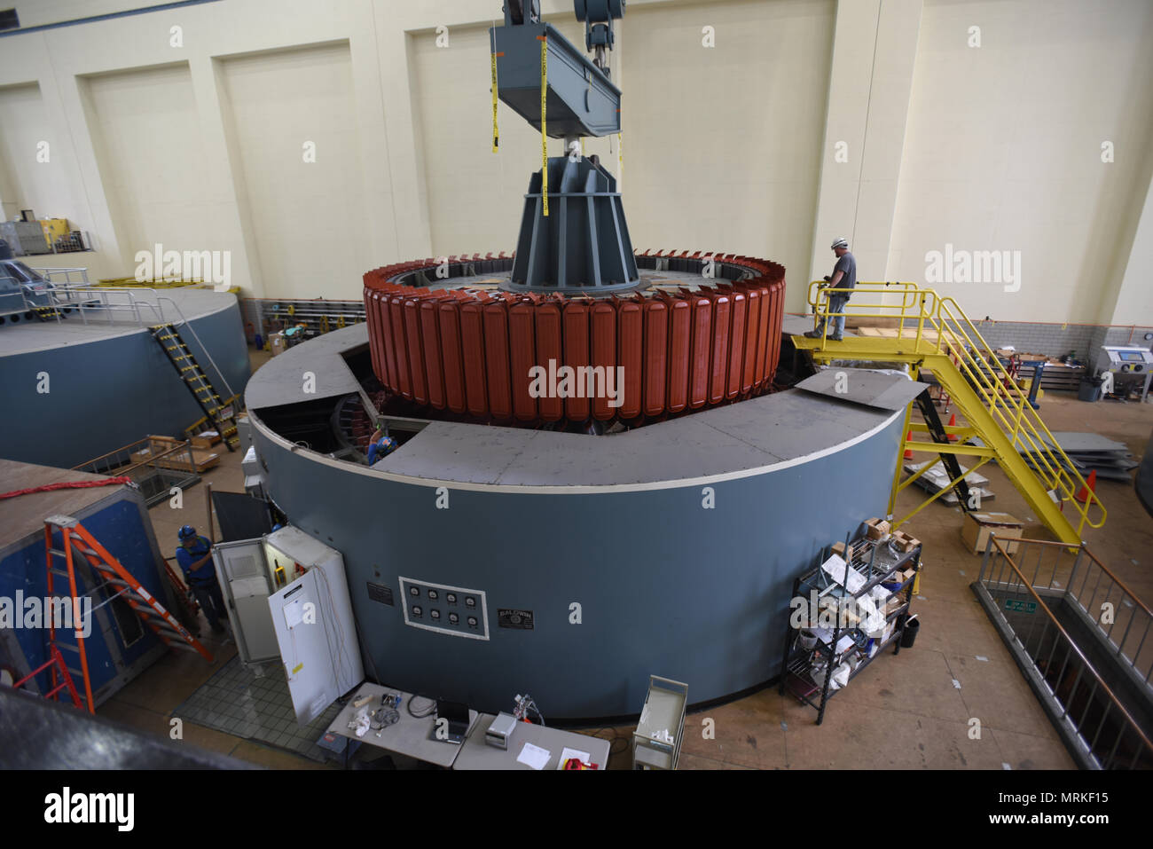 Kye Moss of Voith Hydro guides a 249-ton rotor during its installation ...