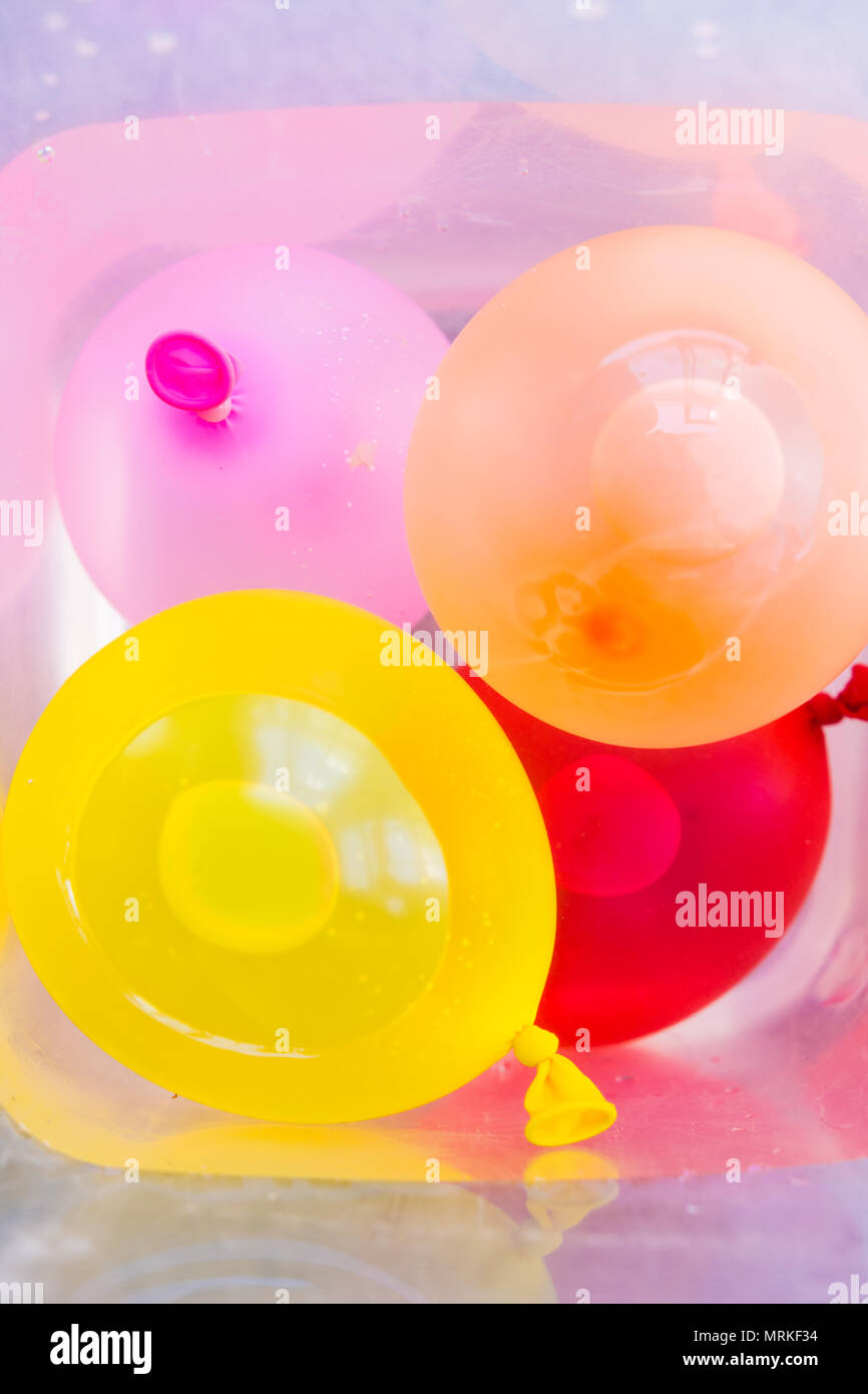 Overhead of small tub of colorful water balloons Stock Photo - Alamy