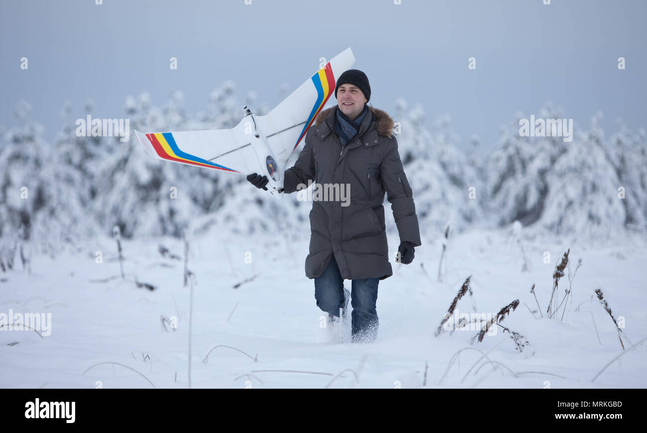 happy man walking on snow winter with rc plane model Stock Photo - Alamy