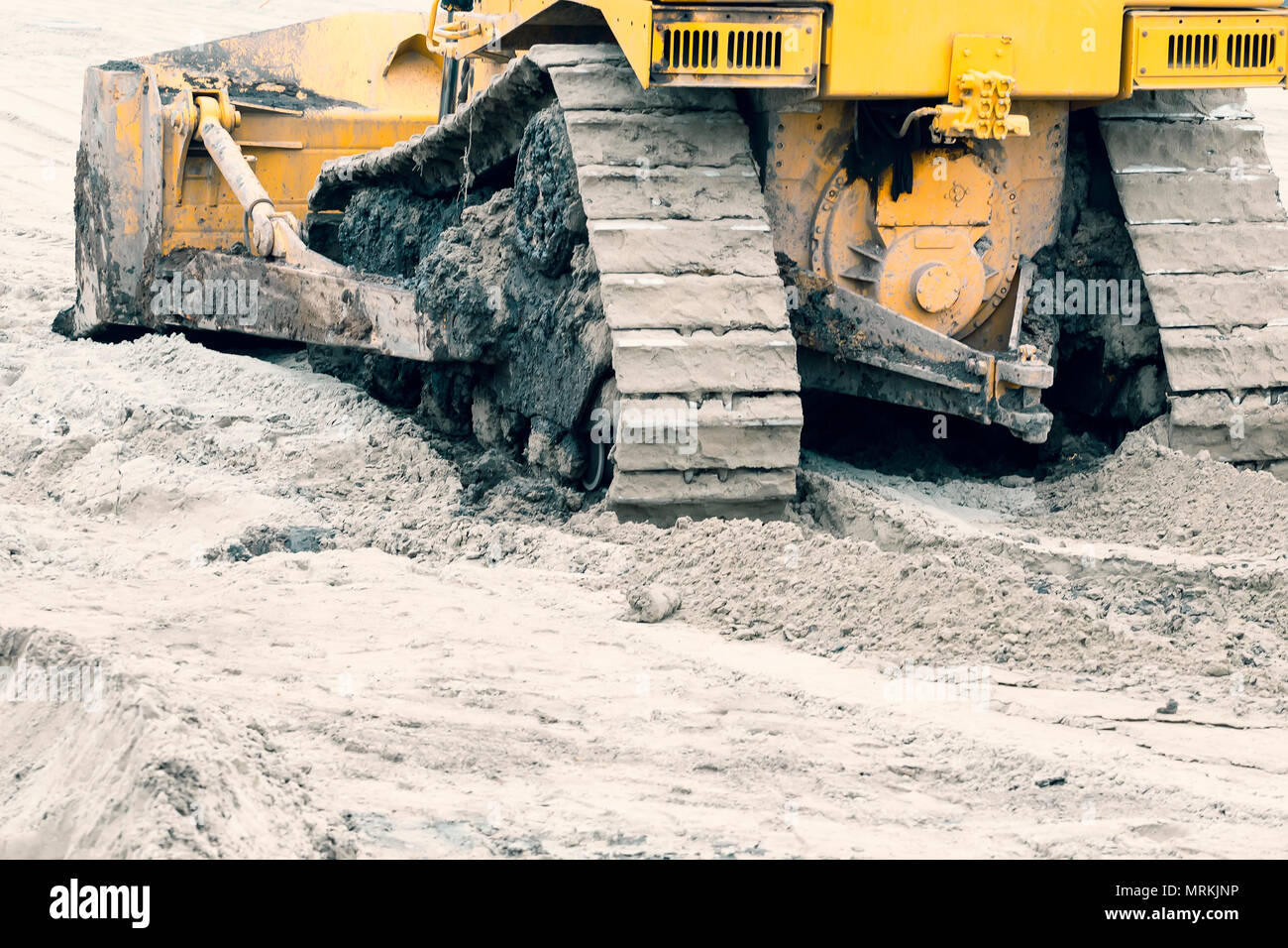 Bulldozer working on road construction site. Selective focus and color ...