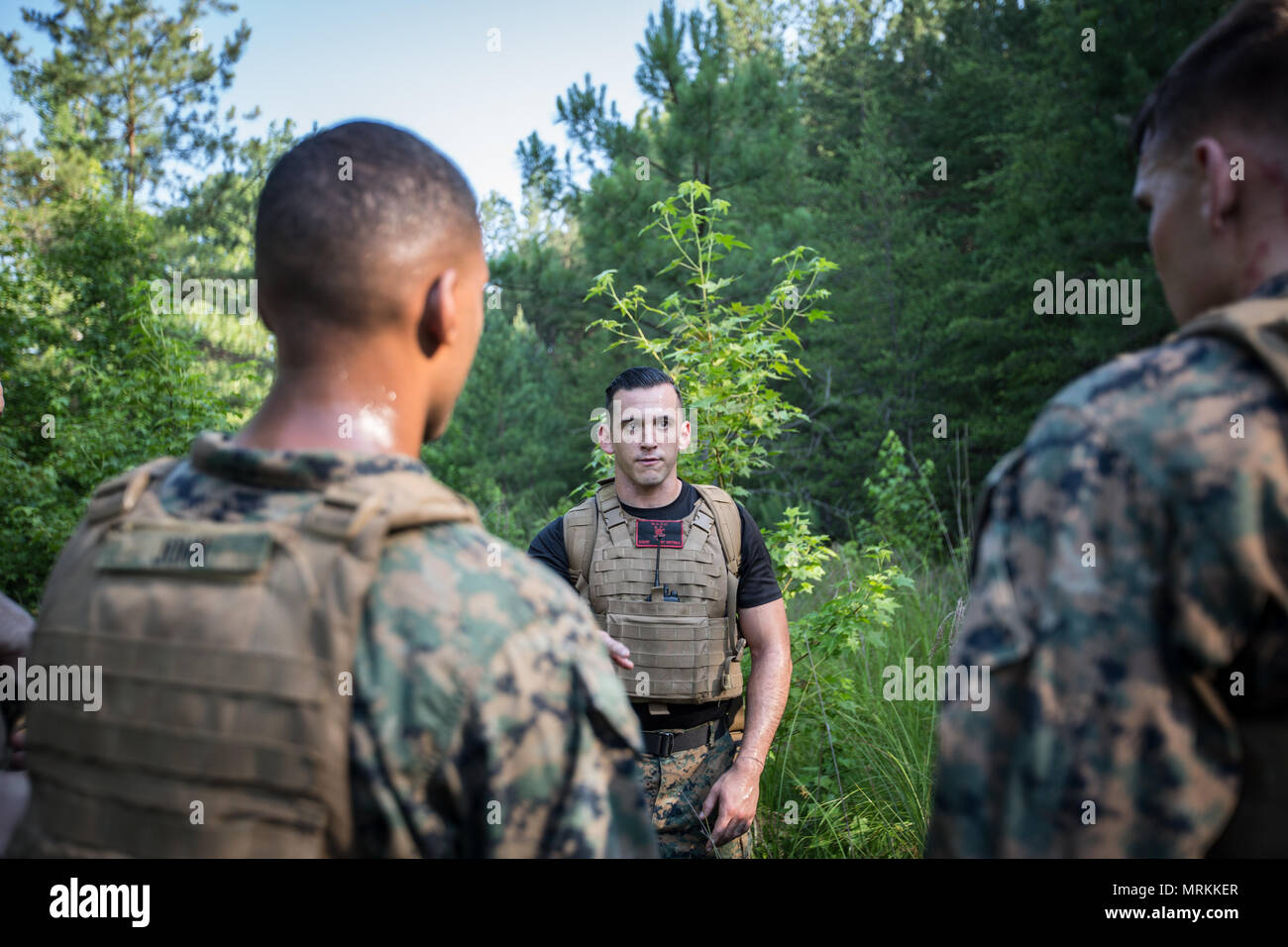 U.S. Marine Corps Sgt. David Ortega (center) delivers a brief prior to ...