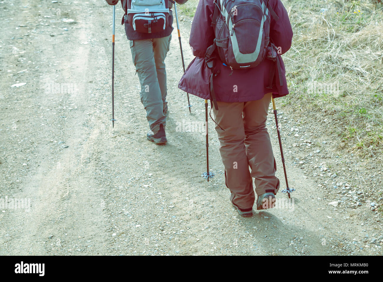 Couple traveling in mountains with hiking equipment, trekking boots and ...