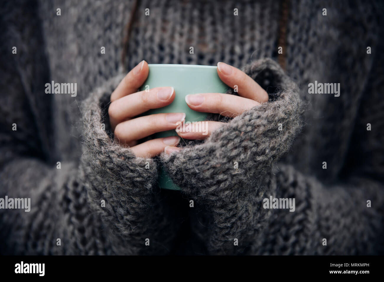Close up view at young woman holding mug outdoor Stock Photo - Alamy