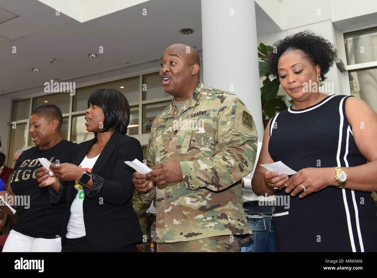 Uniformed and non-uniformed participants sing together at the 3rd ...