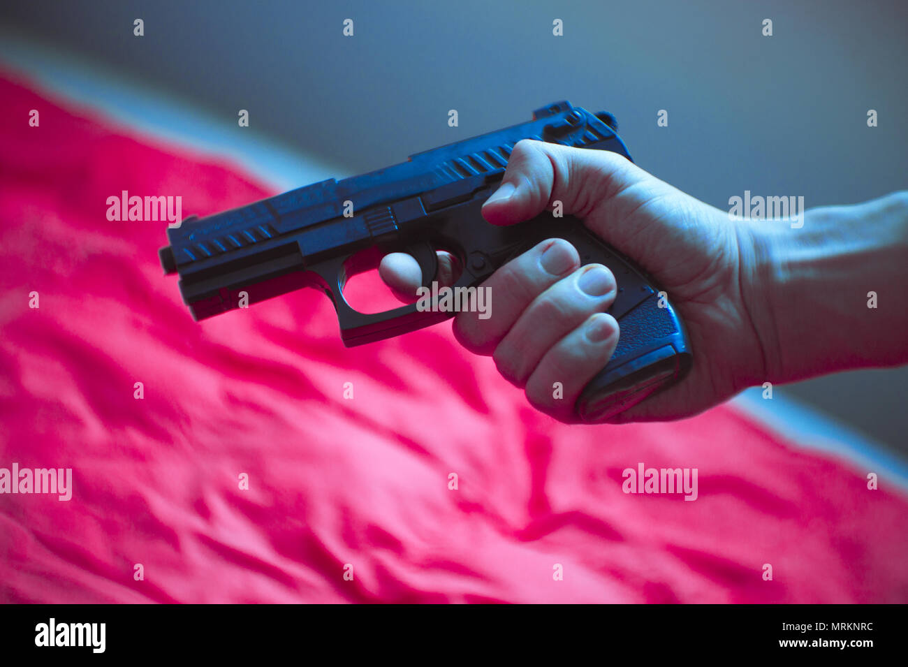 Gun held by a mans hand Stock Photo - Alamy