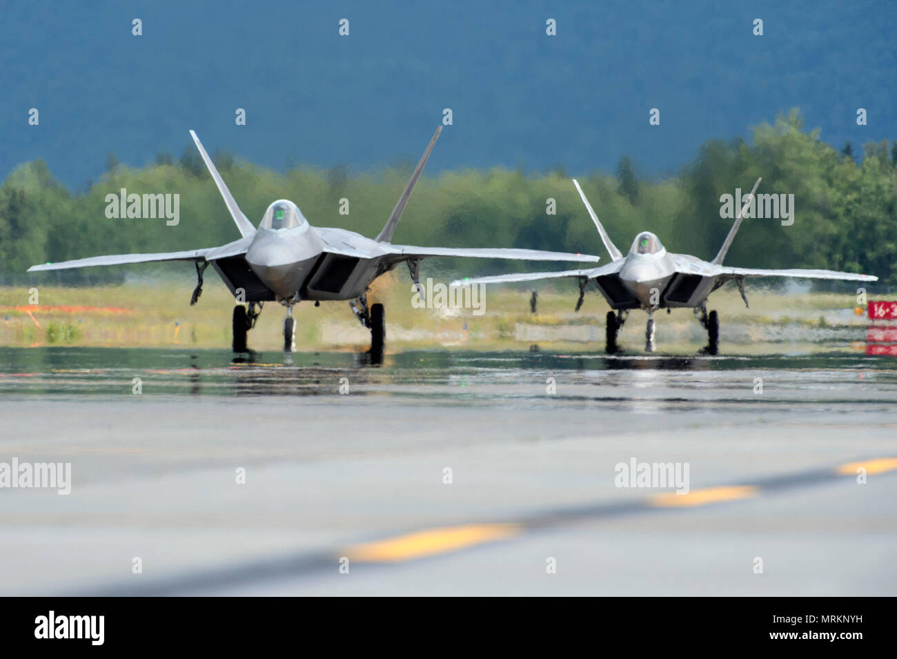 Two U.S. Air Force F-22 Raptors, assigned to the 3rd Wing, taxi before ...