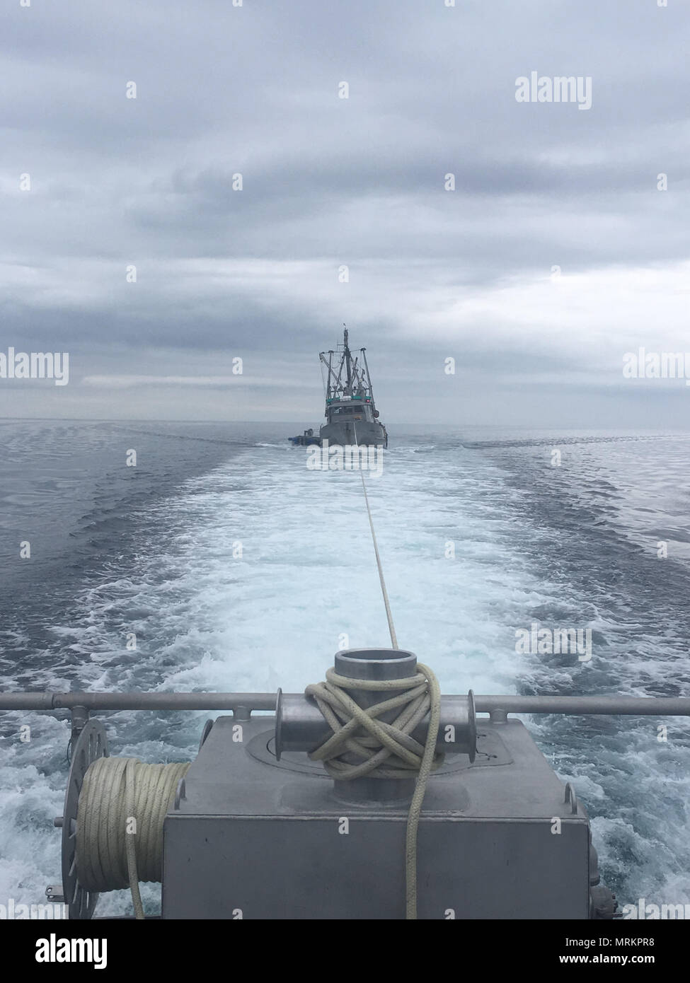 A Coast Guard Station Valdez 45-foot Response Boat-Medium crew tows a ...
