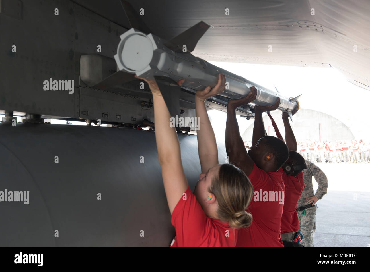 A weapons load team from the 67th Aircraft Maintenance Unit loads an ...