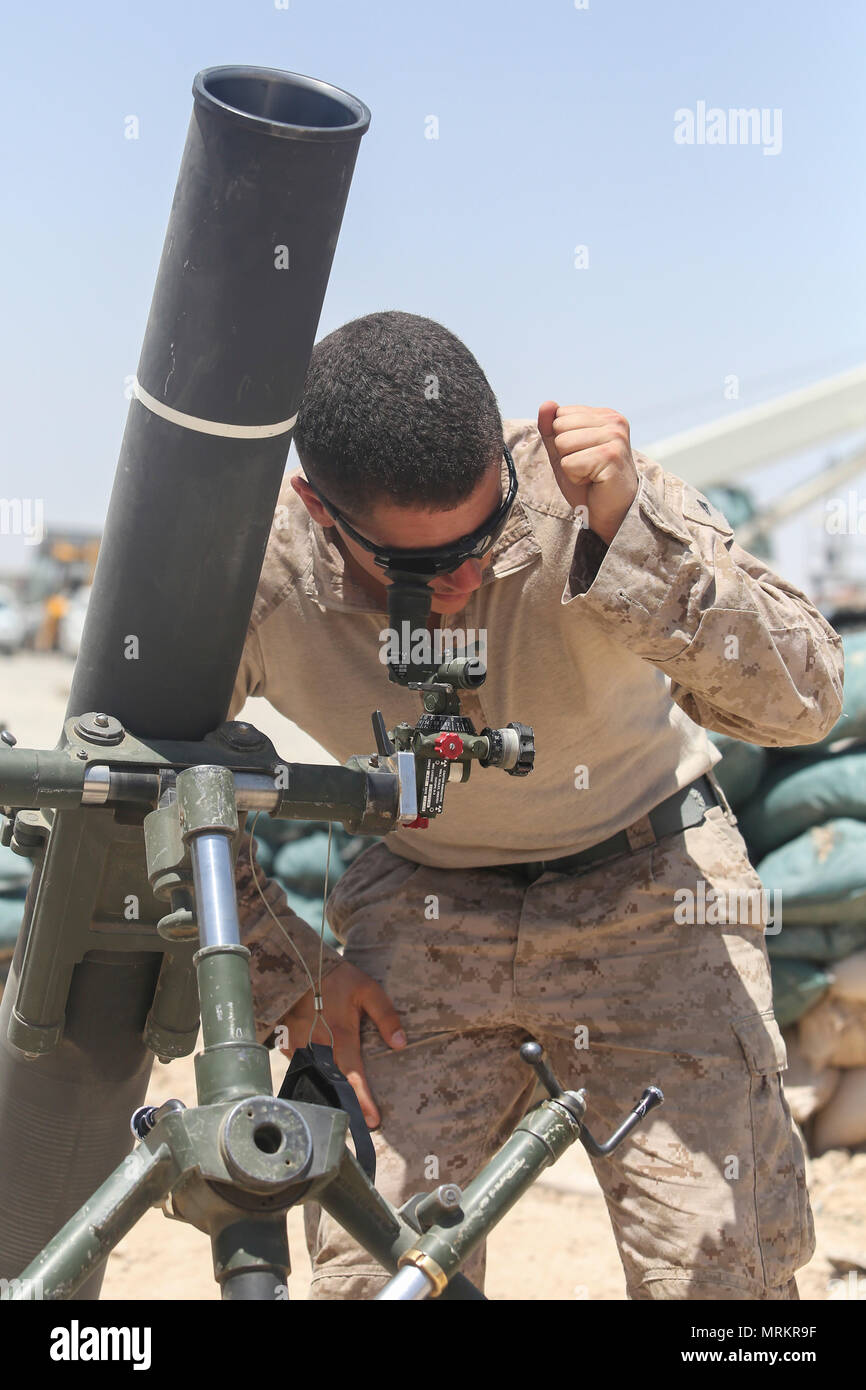 A Marine with Task Force Southwest refers an M64A1 sight and realigns ...