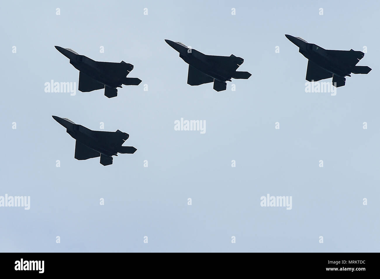 Four U.S. Air Force F-22 Raptors fly in close formation at Joint Base ...