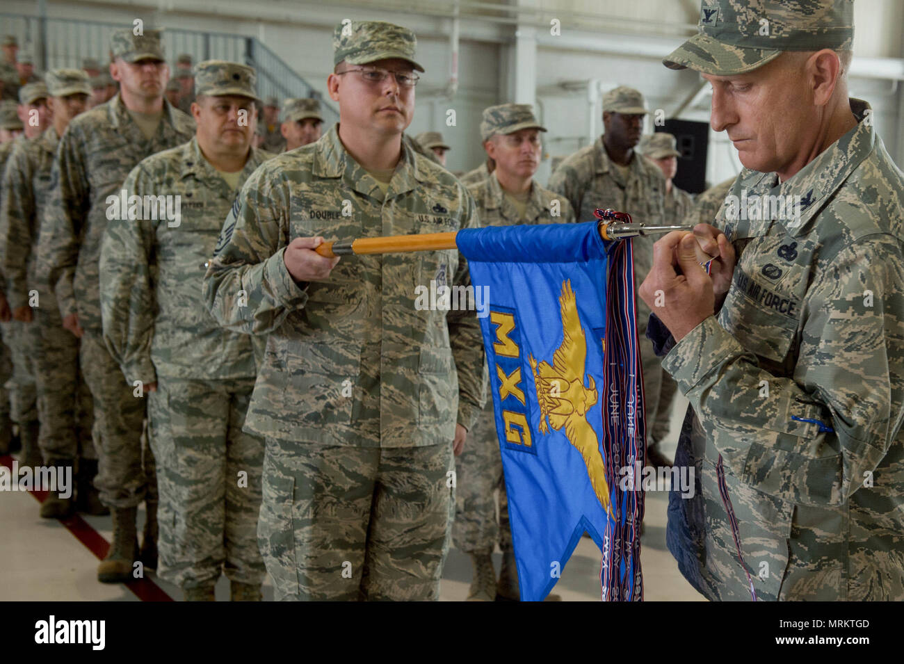 U.S. Air Force Col. Todd Andre, 1st Maintenance Group commander, hangs ...