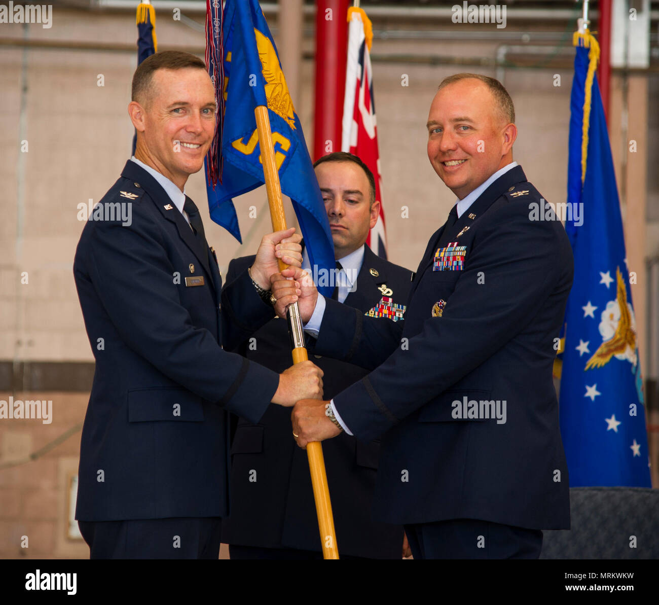 Col. Kevin Gordon, 15th Wing commander, passes the group flag to Col ...