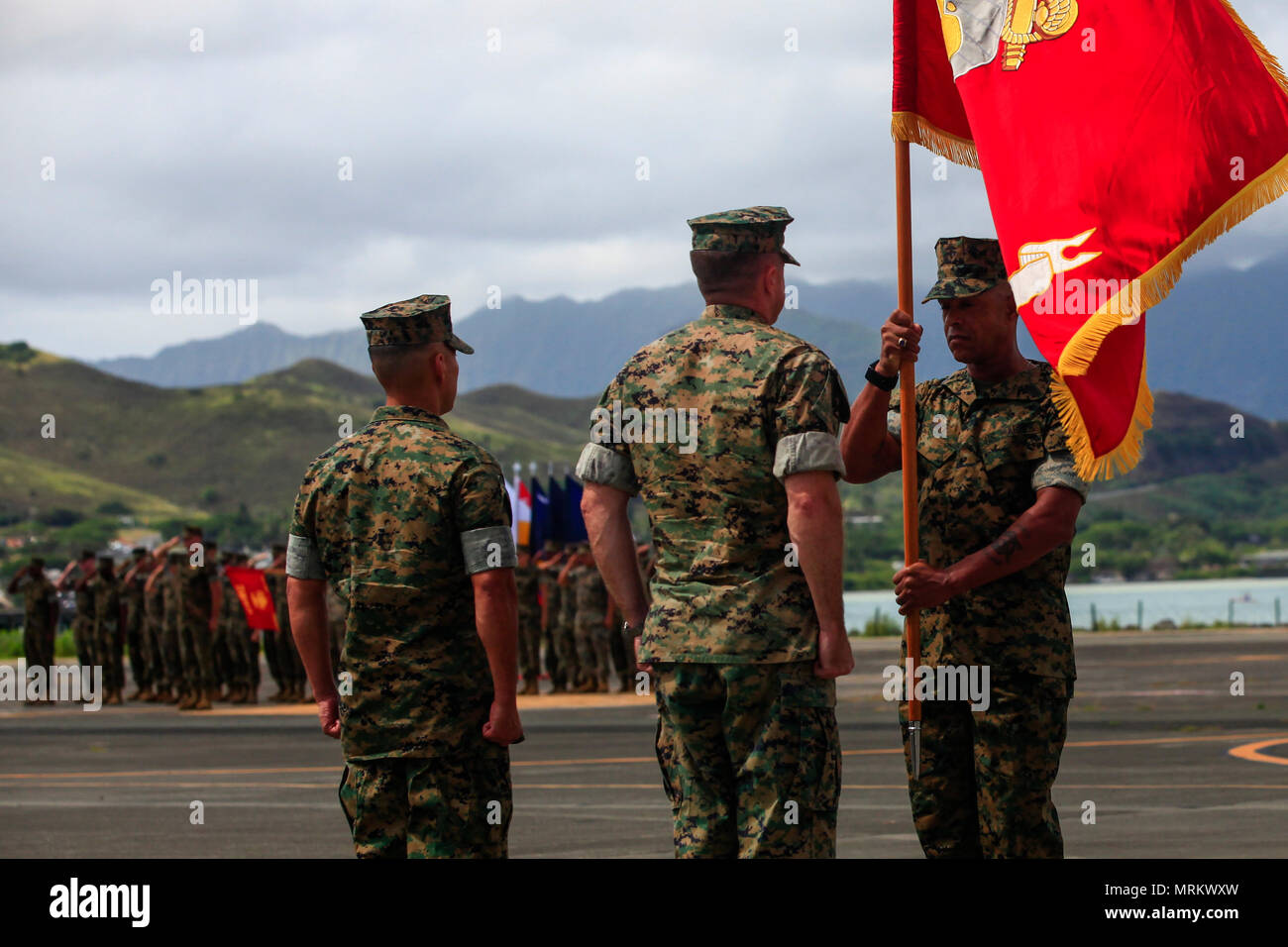 MARINE CORPS BASE HAWAII – Sgt. Maj. Gregory L. Hall passes the Marine Corps flag to Col. Sean C ...